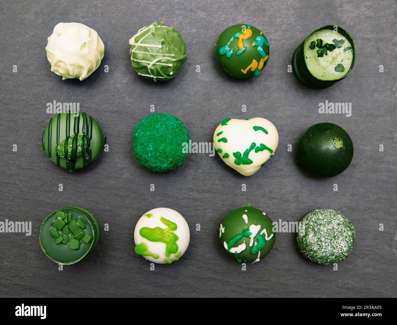 Handmade chocolates. Colored chocolate candies sweets on a gray slate ...