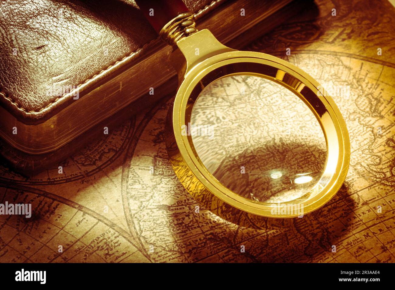 Old map with an magnifying glass Stock Photo - Alamy