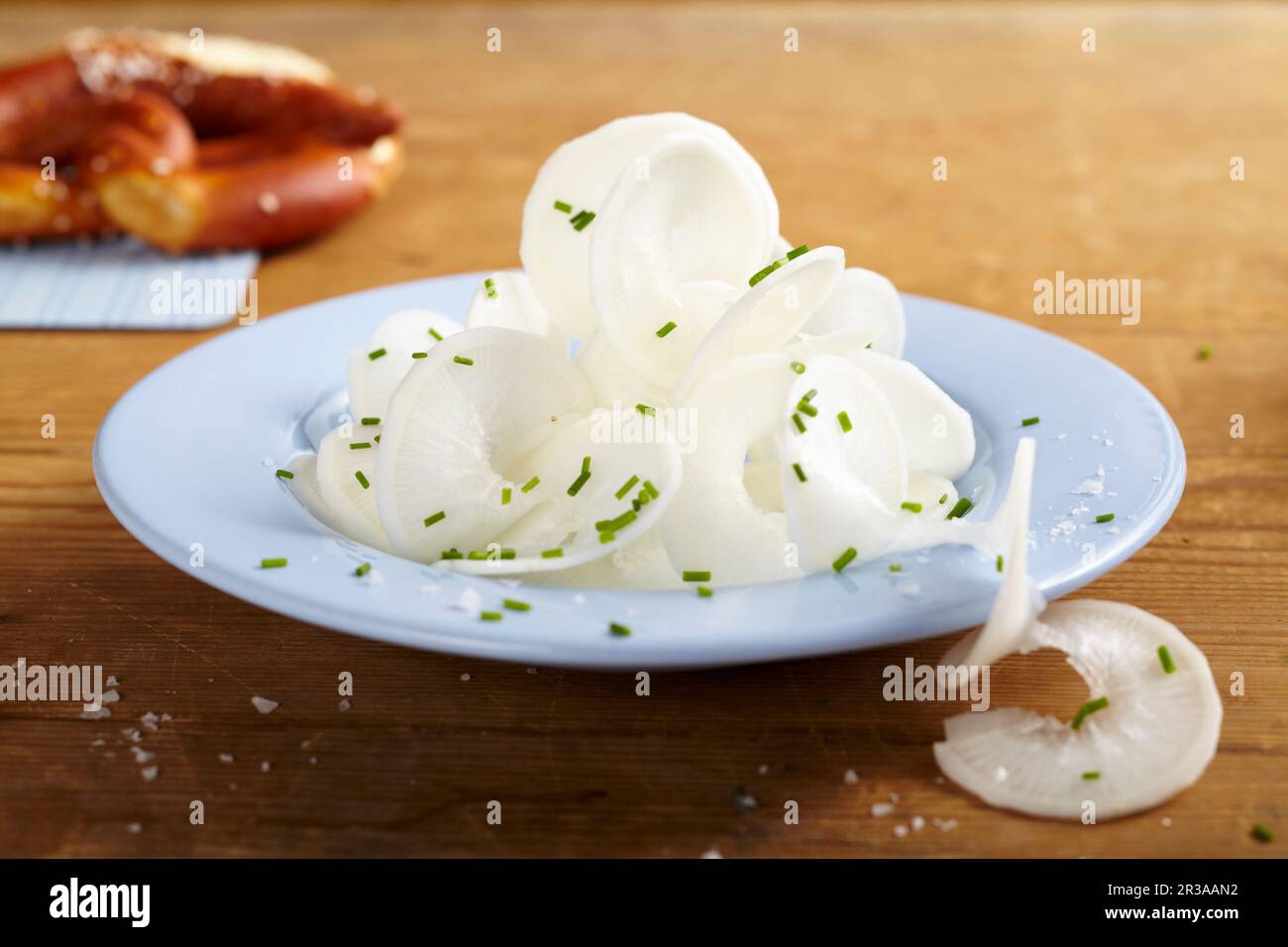 Salted radish spirals on a plate with pretzels as a bavarian snack ...