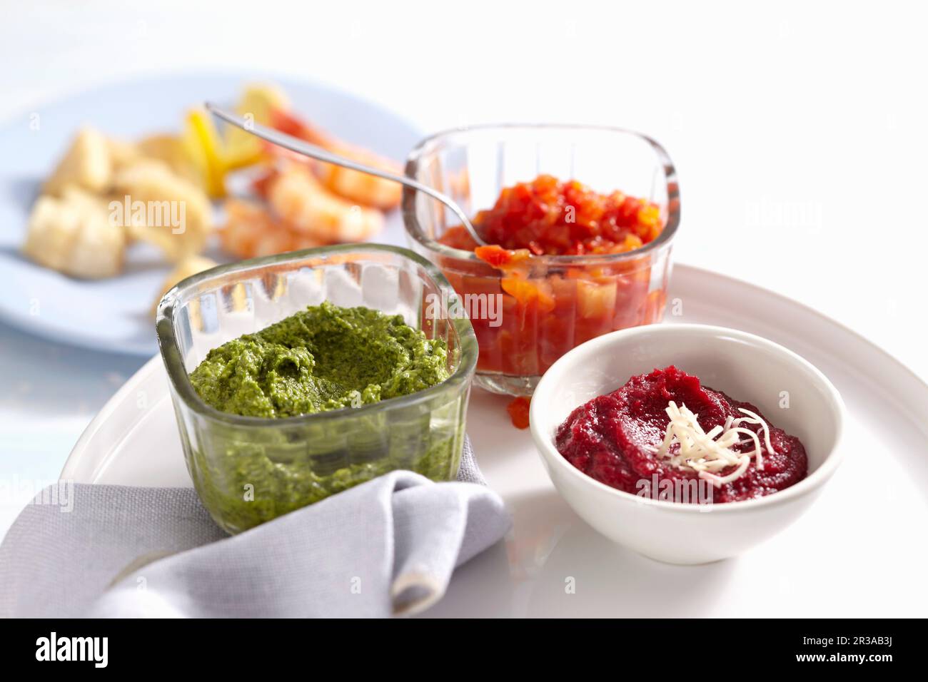 Bowls of various sauces for a fish fondue (exotic chutney, beetroot and ...
