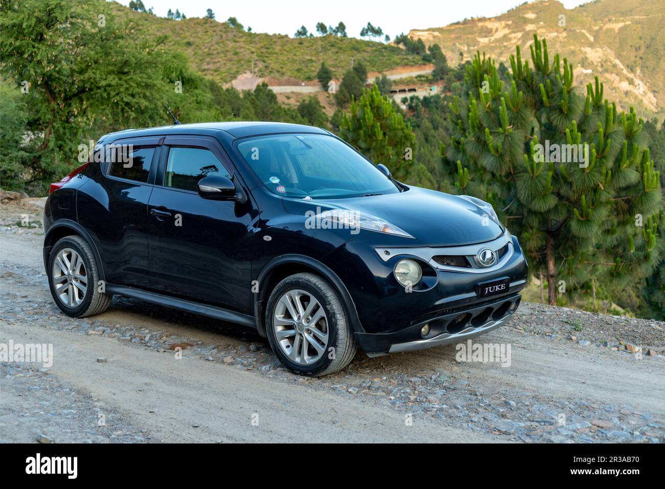 Nissan Juke Impul black japanese in a countryside of Pakistan mountain ...