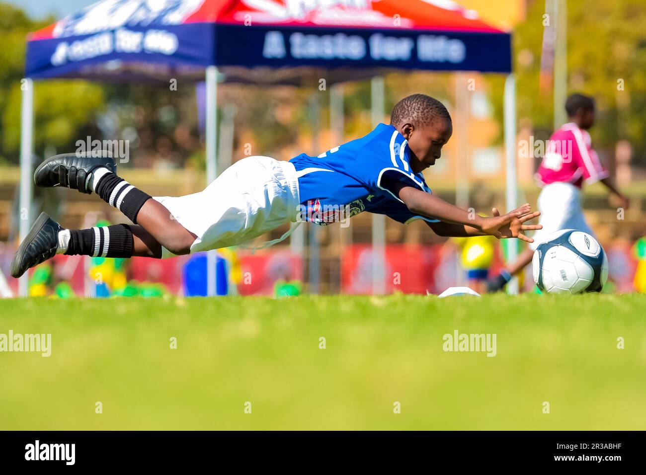Diverse children playing soccer football at school Stock Photo - Alamy