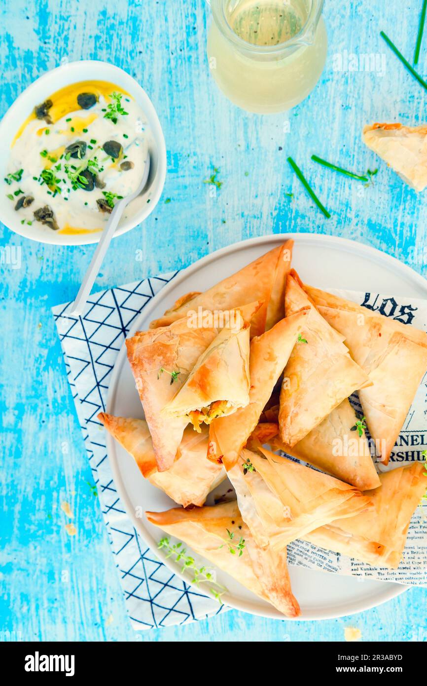 Phillo pasta triangles with carrots and zucchini served with caper ...