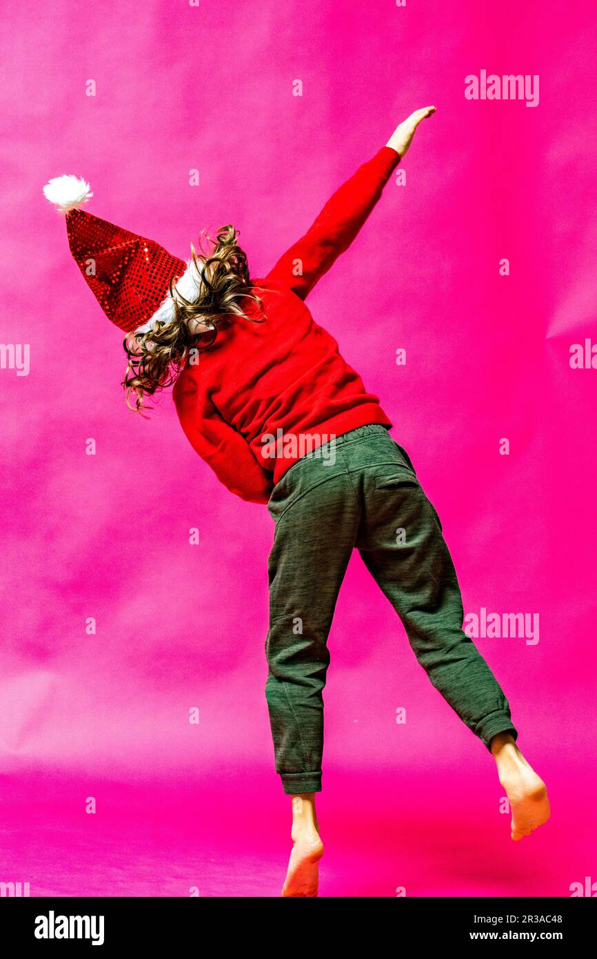 children with Christmas hat jumping Stock Photo - Alamy