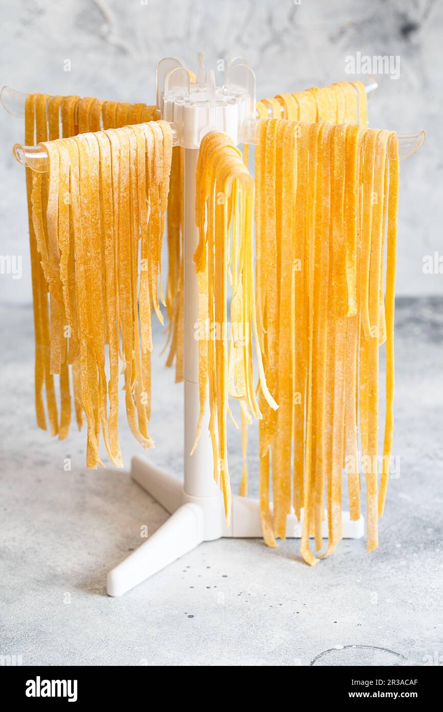 Homemade pasta linguine hanging on rack to dry. Homemade Italian ...