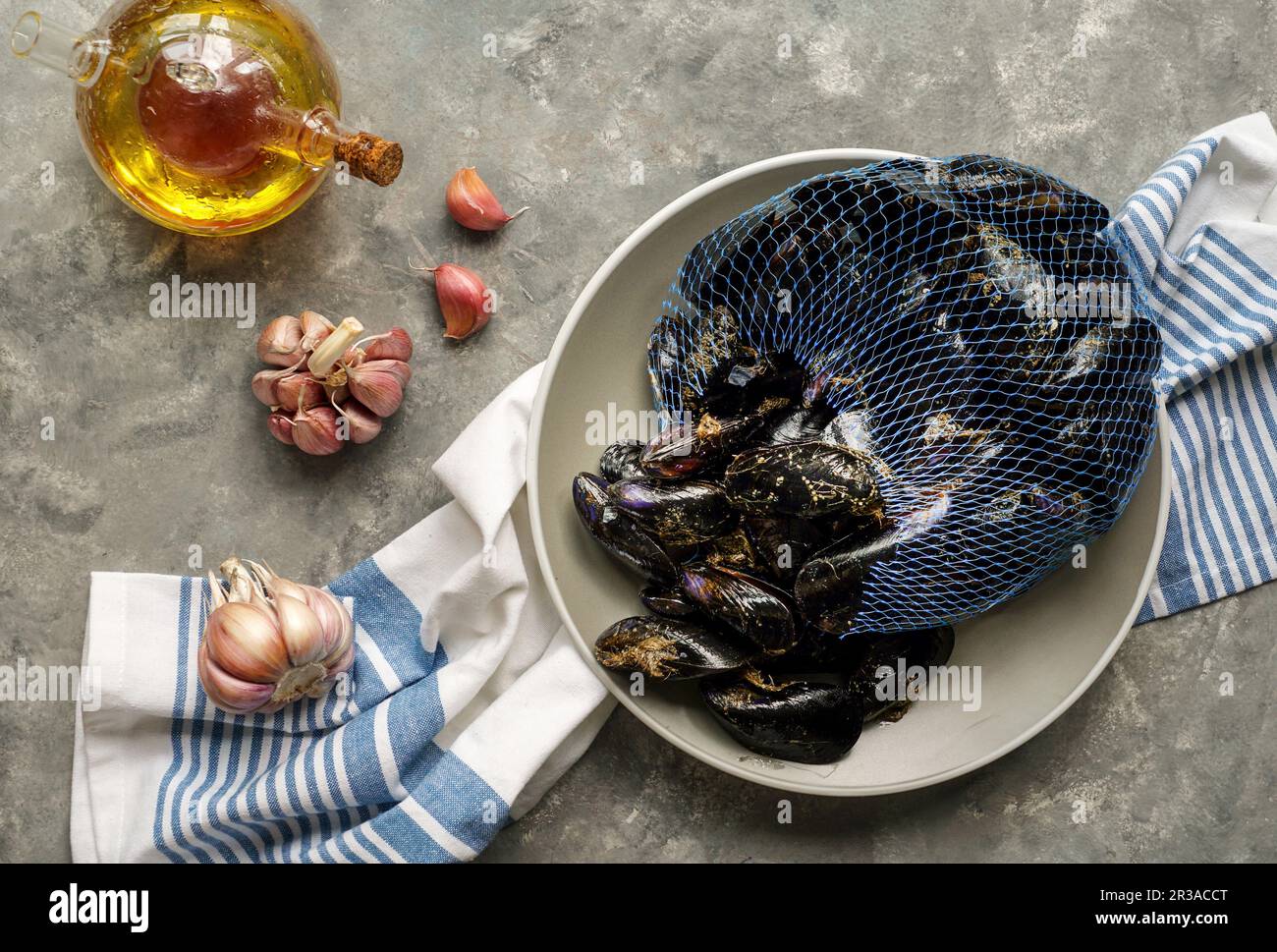 Fresh raw sea mussels with garlic ready to be cooked Stock Photo - Alamy
