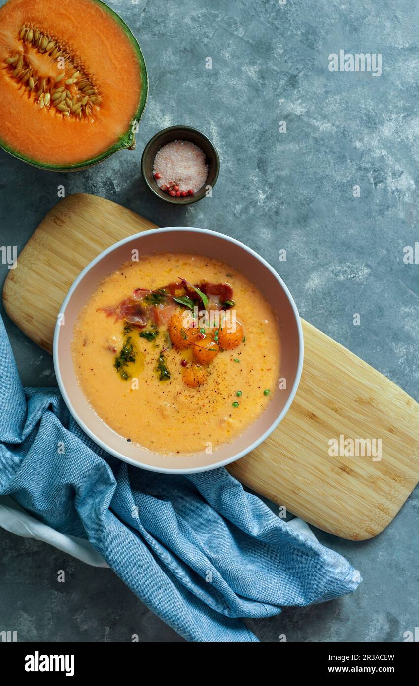 Orange melon cold soup, with jamon, typical spanish dish Stock Photo ...