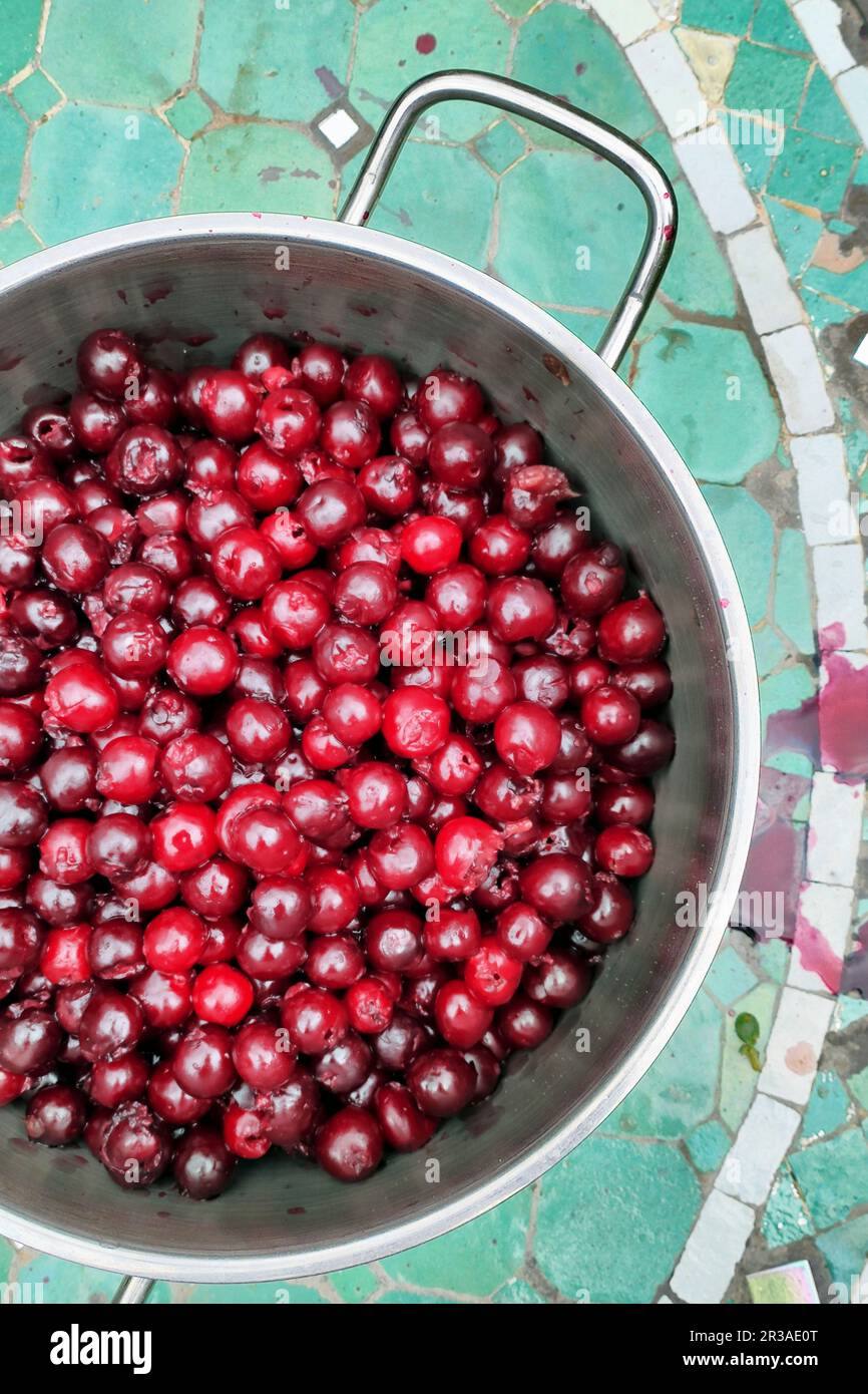 Stoned cherries in a pot Stock Photo - Alamy