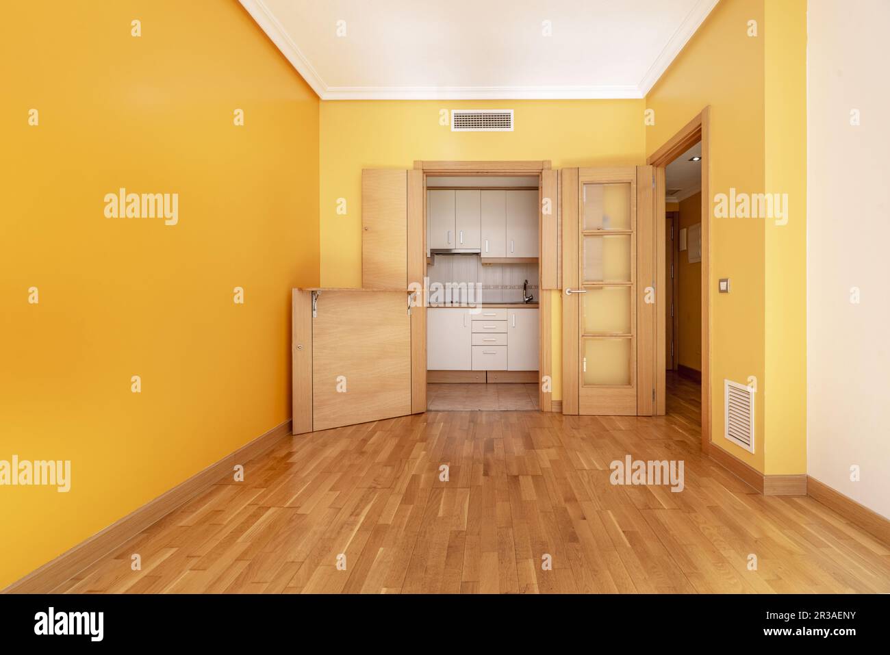 Living room of an empty house with a folding access and serving hatch ...
