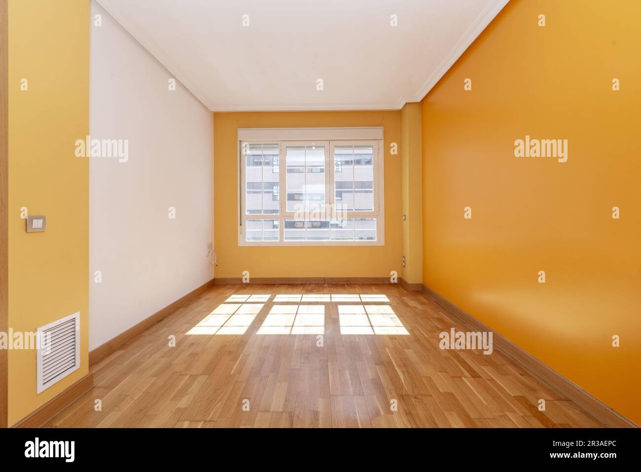 Living room of an empty house with a large white aluminum window with ...