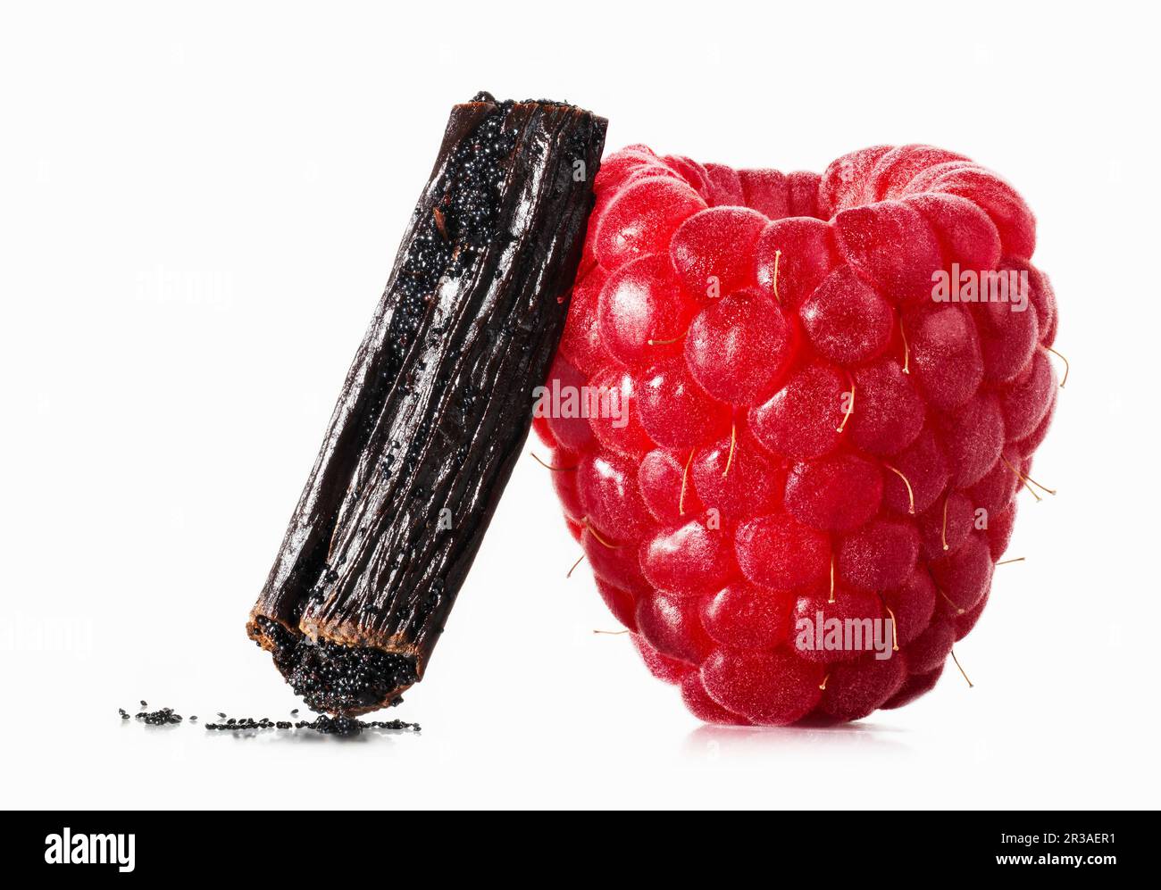 Red raspberry with small section of vanilla bean leaning against it ...