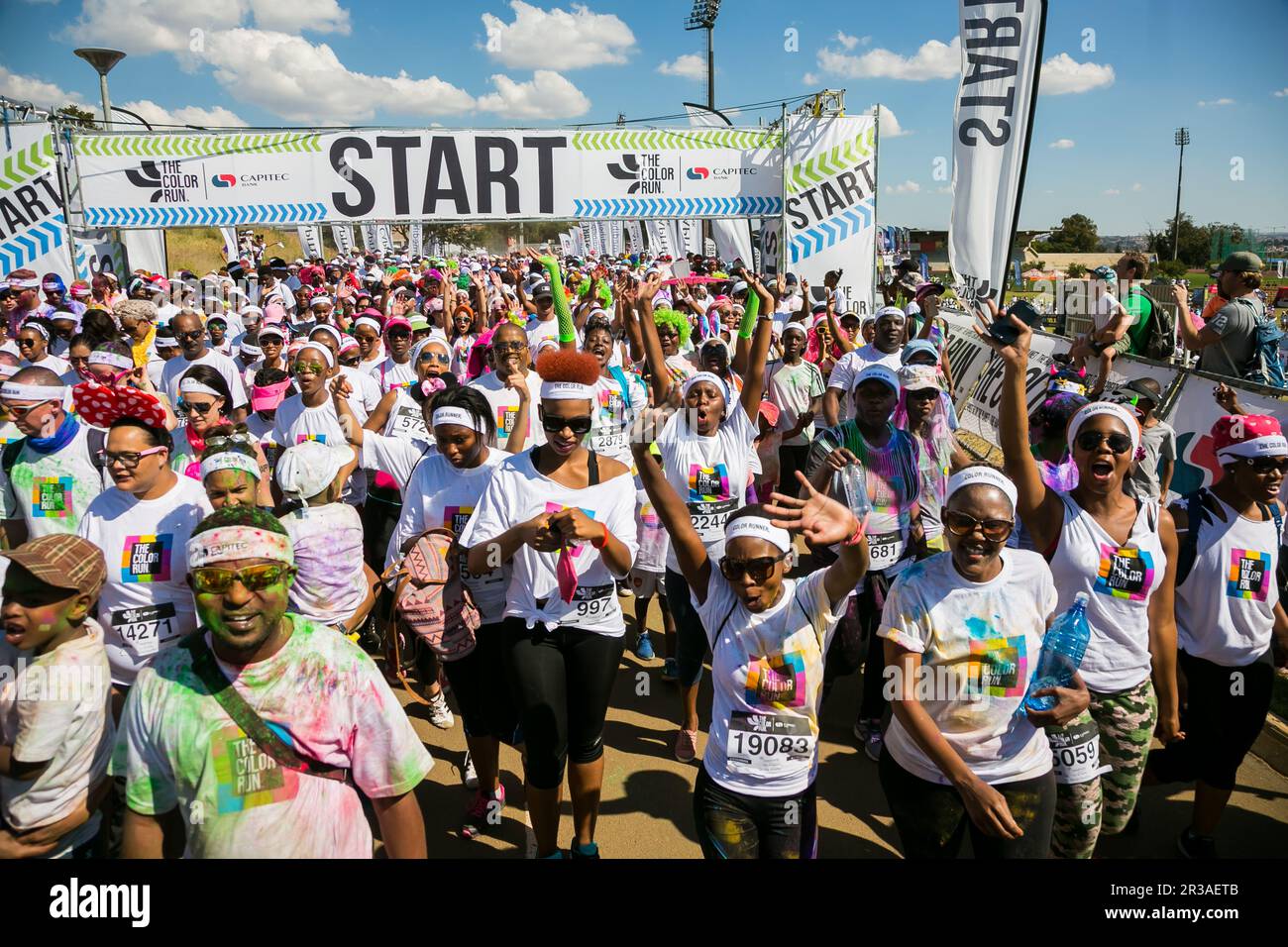 Diverse people running in The Color Run Marathon in Soweto Stock Photo ...