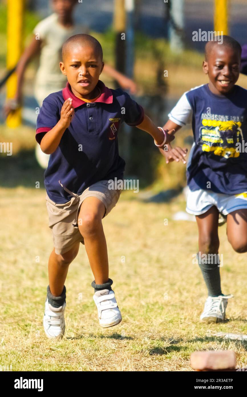 Diverse African Primary School children doing physical exercise PT ...