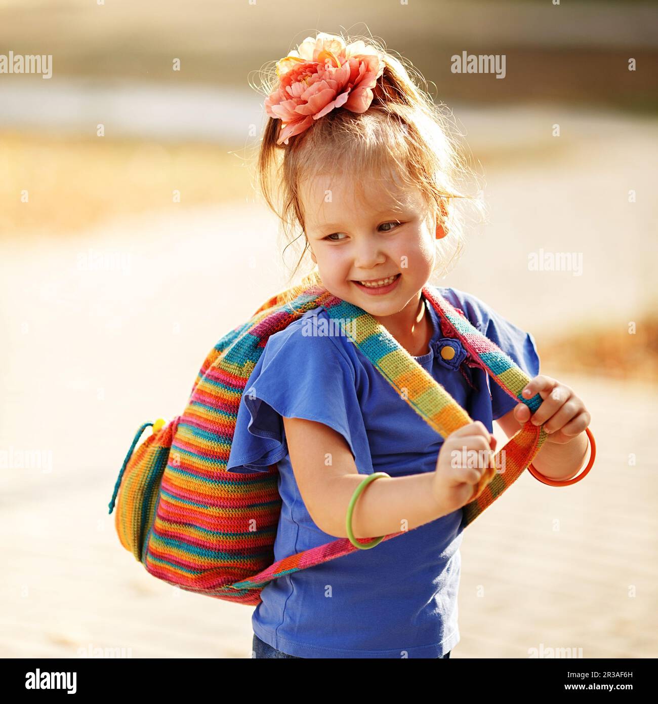 Portrait of an adorable preschool age girl with colorful knitted ...