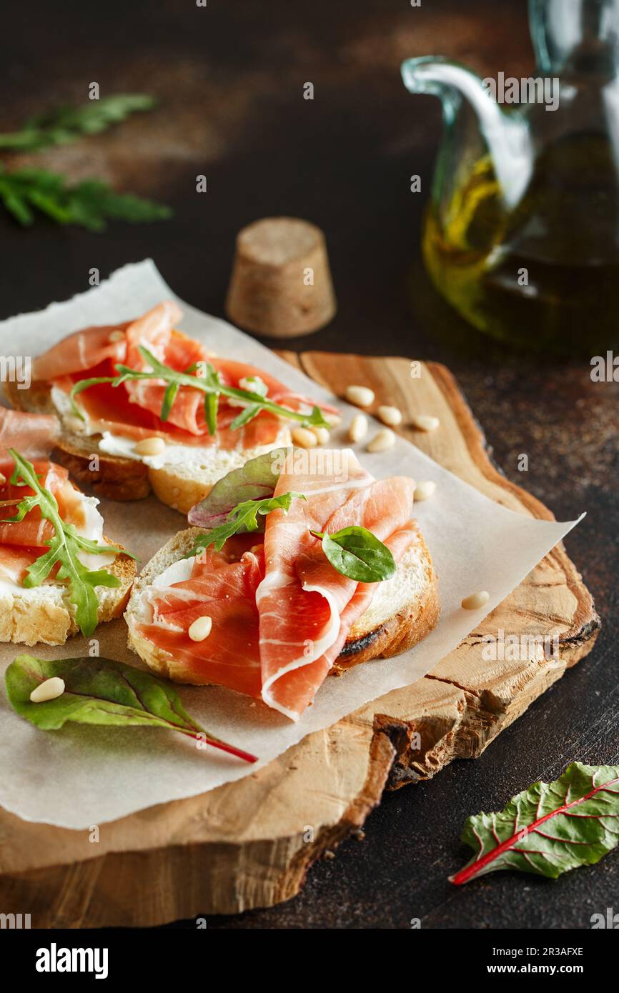 Traditional parma cured ham antipasto. Bruschetta set with Parma Ham ...