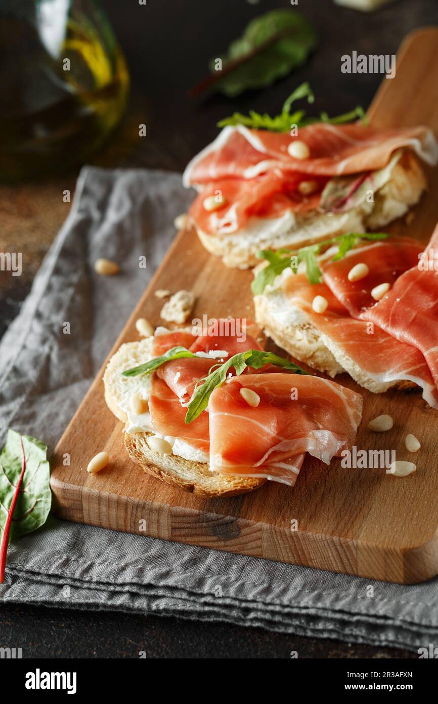 Traditional parma cured ham antipasto. Bruschetta set with Parma Ham ...