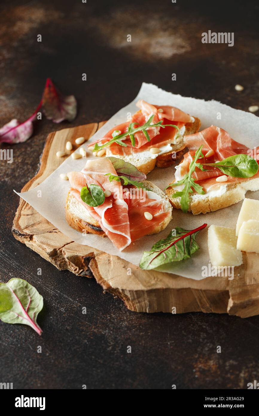 Traditional parma cured ham antipasto. Bruschetta set with Parma Ham ...