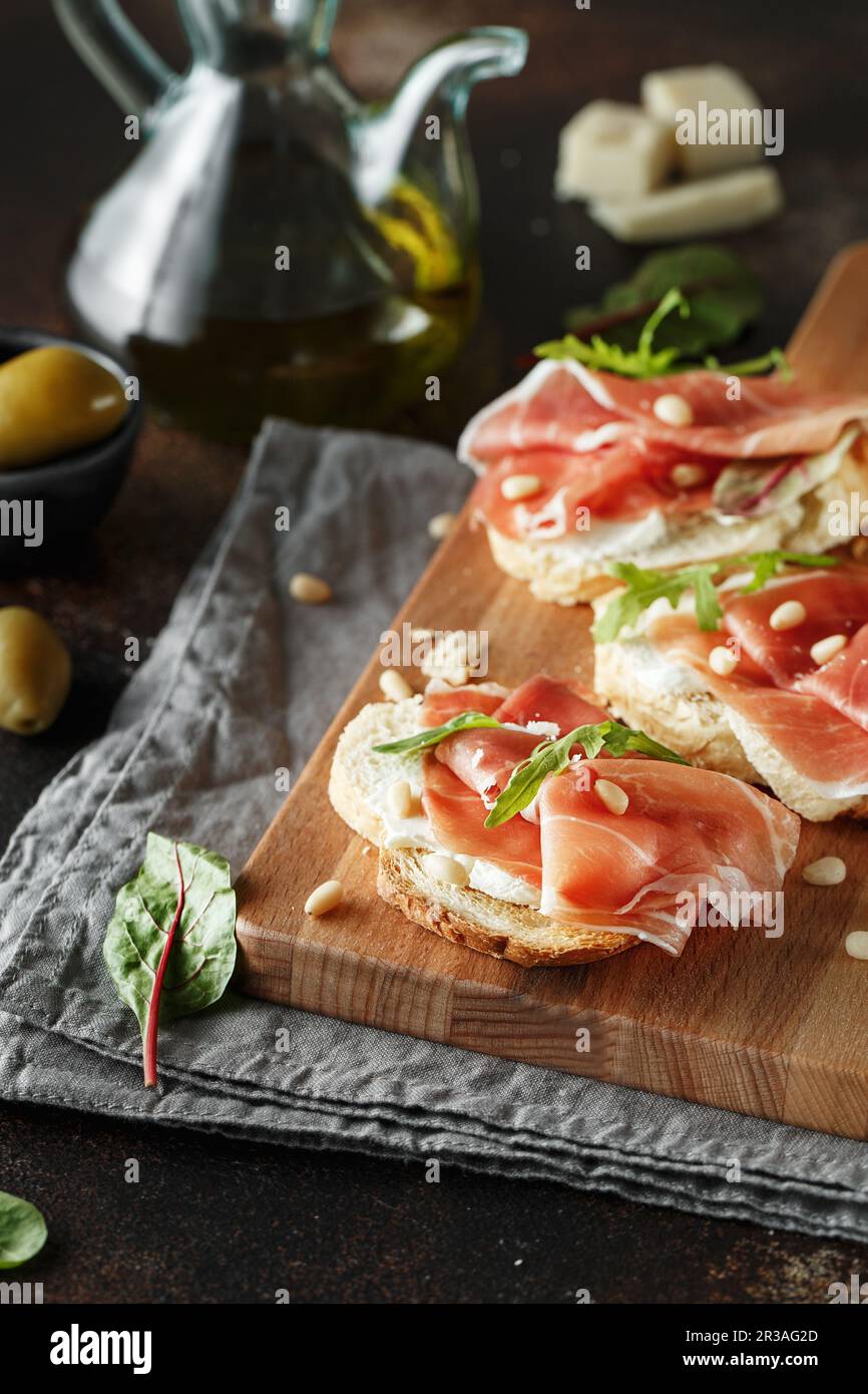 Traditional parma cured ham antipasto. Bruschetta set with Parma Ham ...