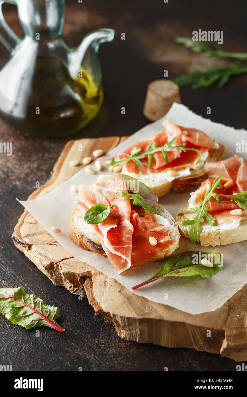 Traditional parma cured ham antipasto. Bruschetta set with Parma Ham ...