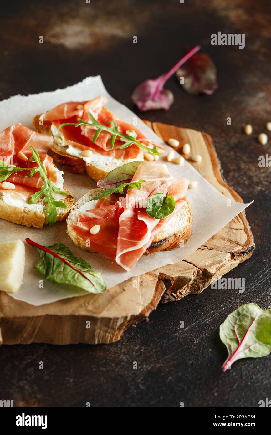 Traditional parma cured ham antipasto. Bruschetta set with Parma Ham ...