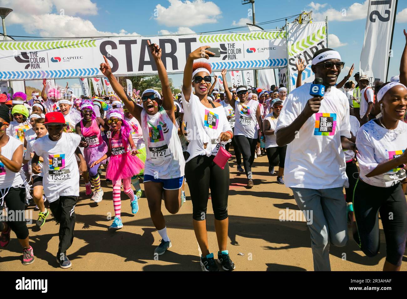 Diverse people running in The Color Run Marathon in Soweto Stock Photo ...