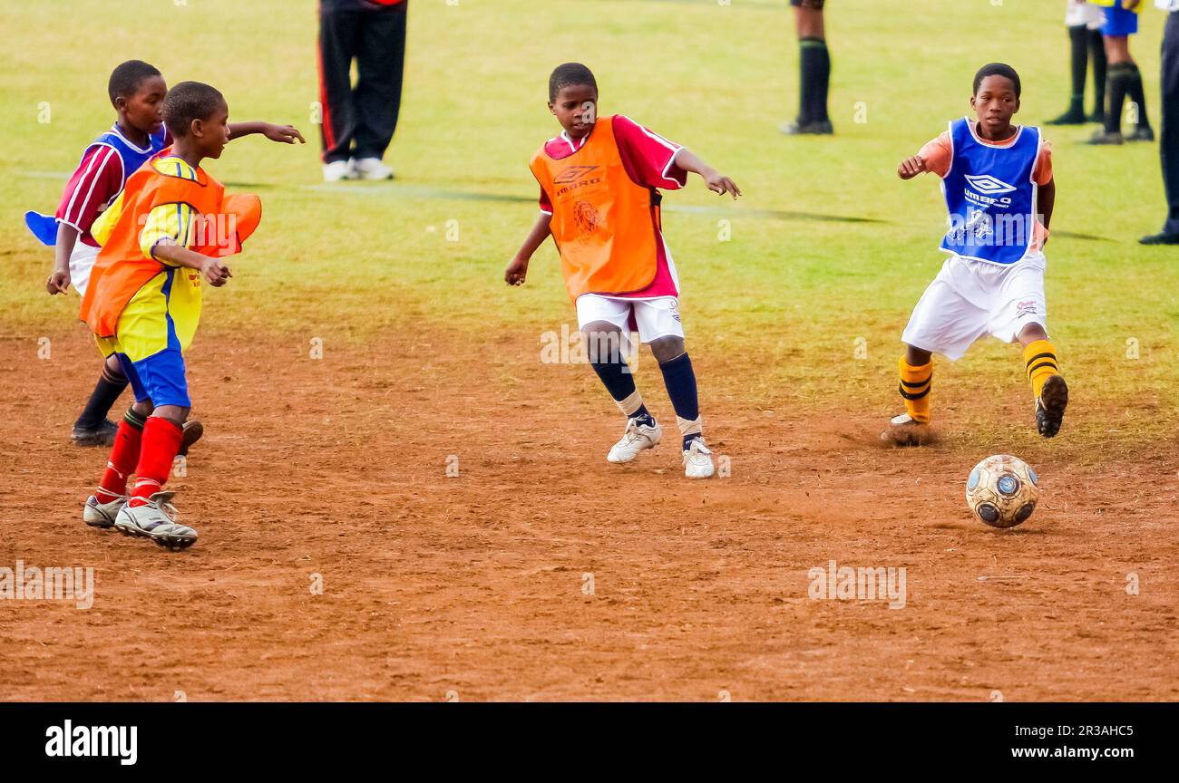 Diverse children playing soccer football at school Stock Photo - Alamy