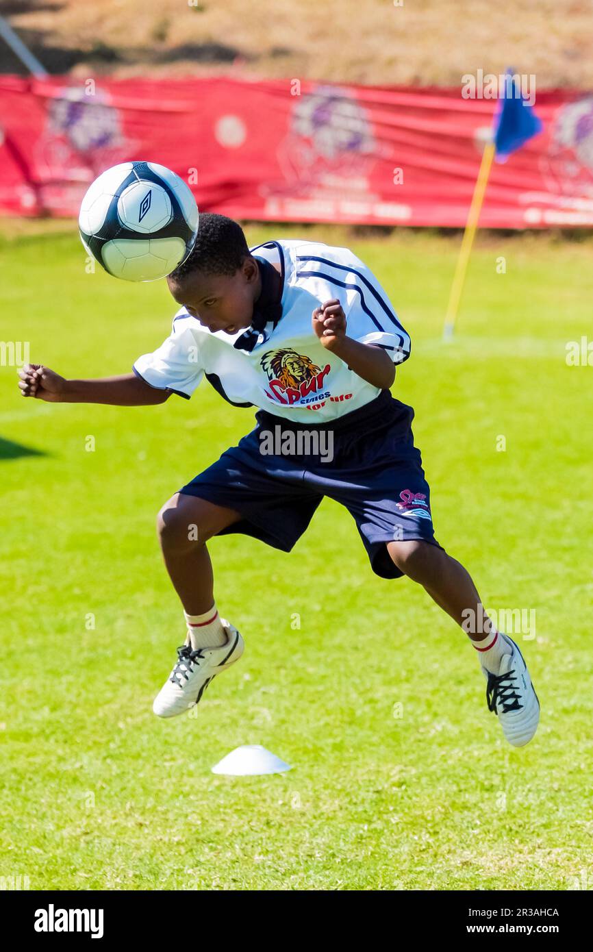 Diverse children playing soccer football at school Stock Photo - Alamy