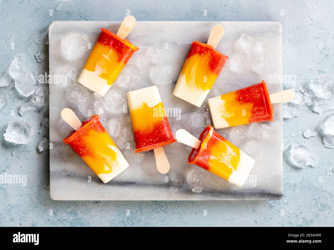 Vegan mango raspberry popsicles Stock Photo - Alamy