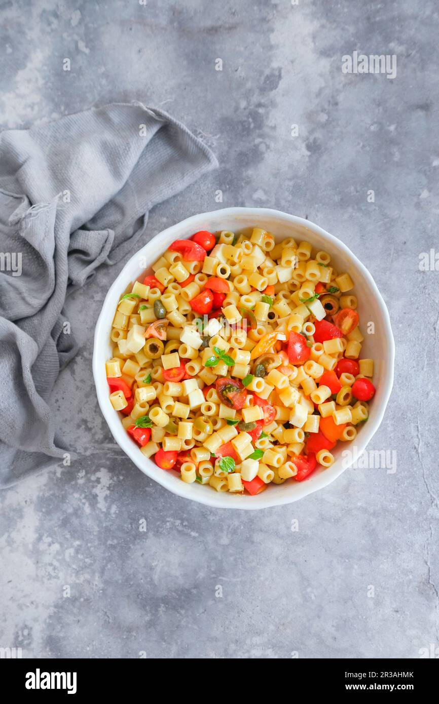 Cold pasta with mozzarella cherry tomatoes capers olives and aromatic ...