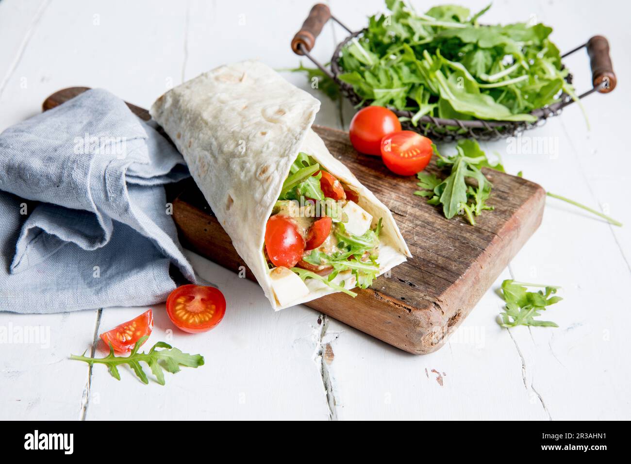 A wrap with tomatoes, mozzarella and rocket salad Stock Photo - Alamy