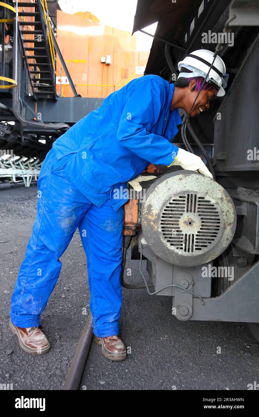 Female Technician checking equipment at Coal Burning Power Station ...