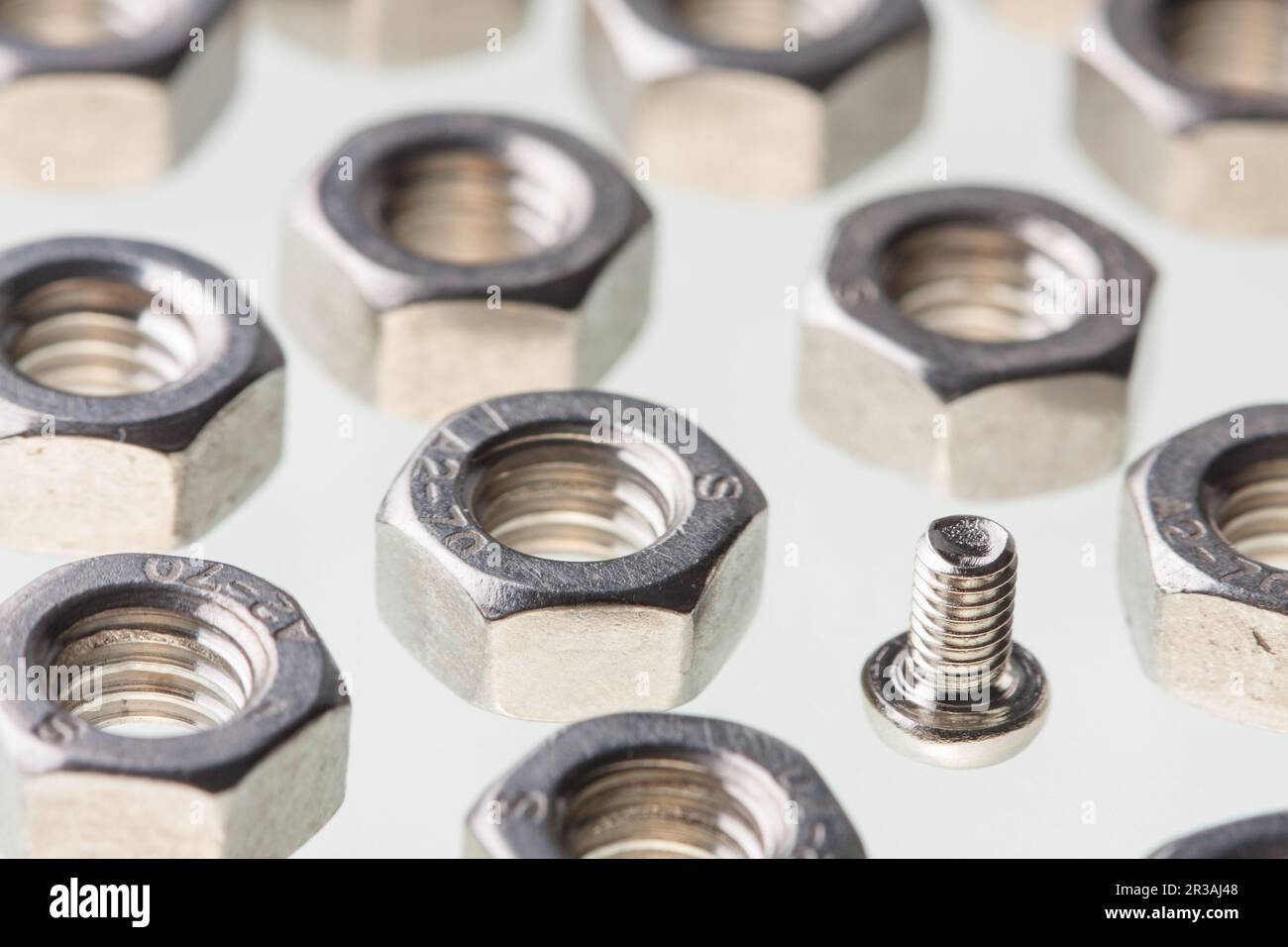 Metallic steel hex nuts and a small fastener bolt Stock Photo - Alamy