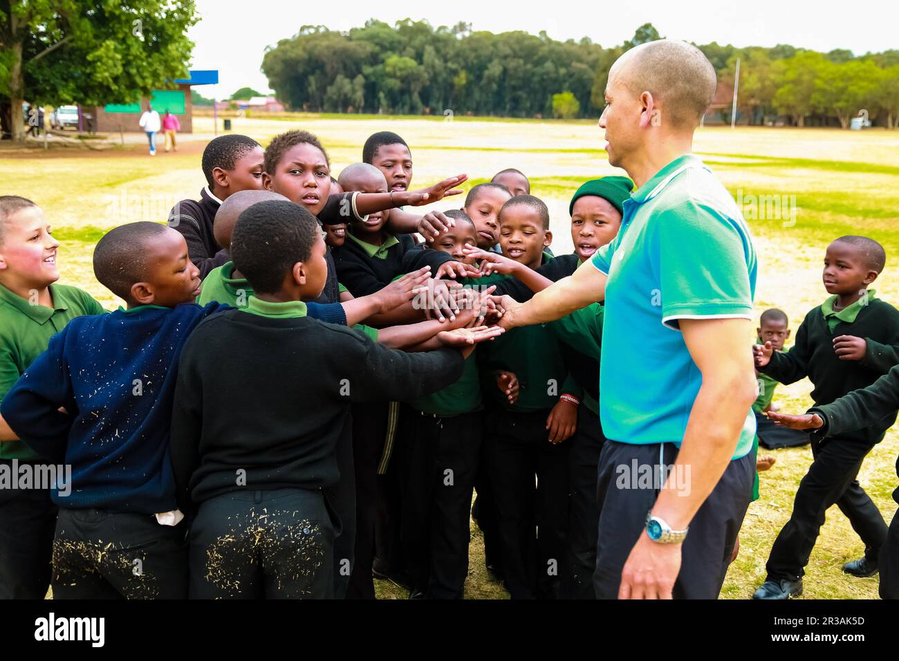 Diverse African Primary School children doing physical exercise PT ...
