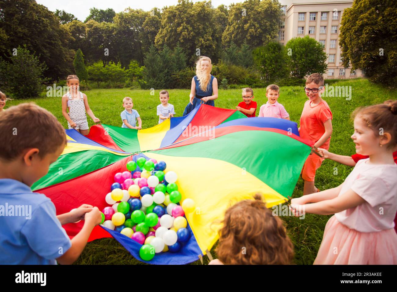 Close view colorful parachute with balls. Kids in circle Stock Photo ...
