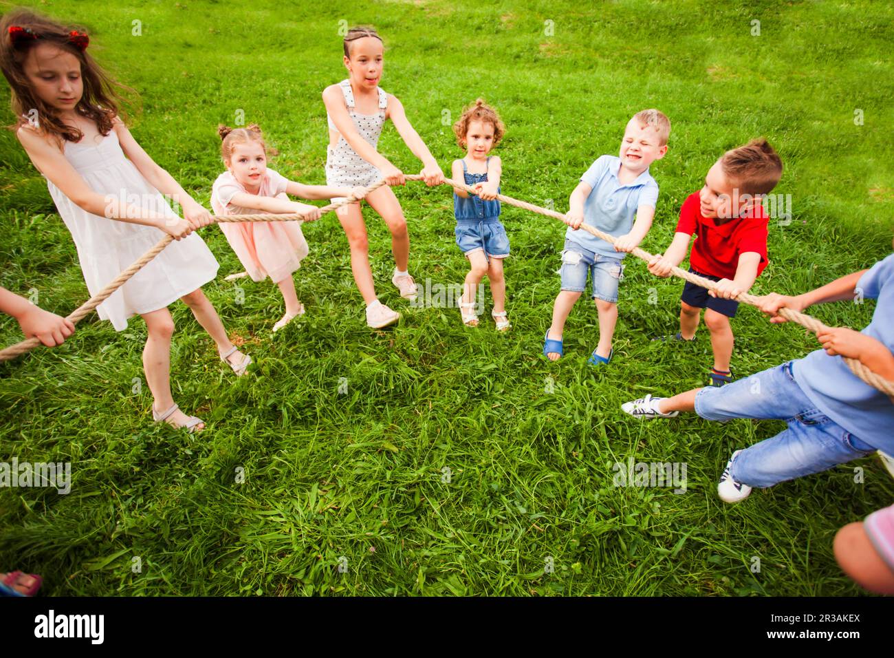 Children play with a rope in the park Stock Photo - Alamy