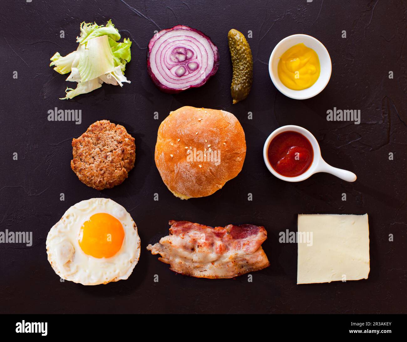 Top view burger components on black background Stock Photo - Alamy
