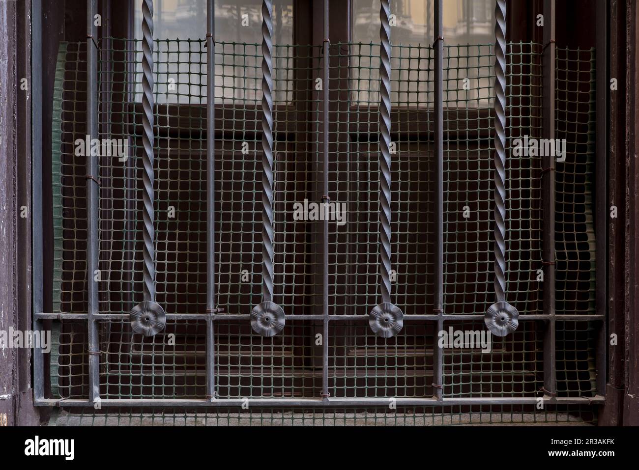 Metal wrought iron fence of a window at street level Stock Photo - Alamy