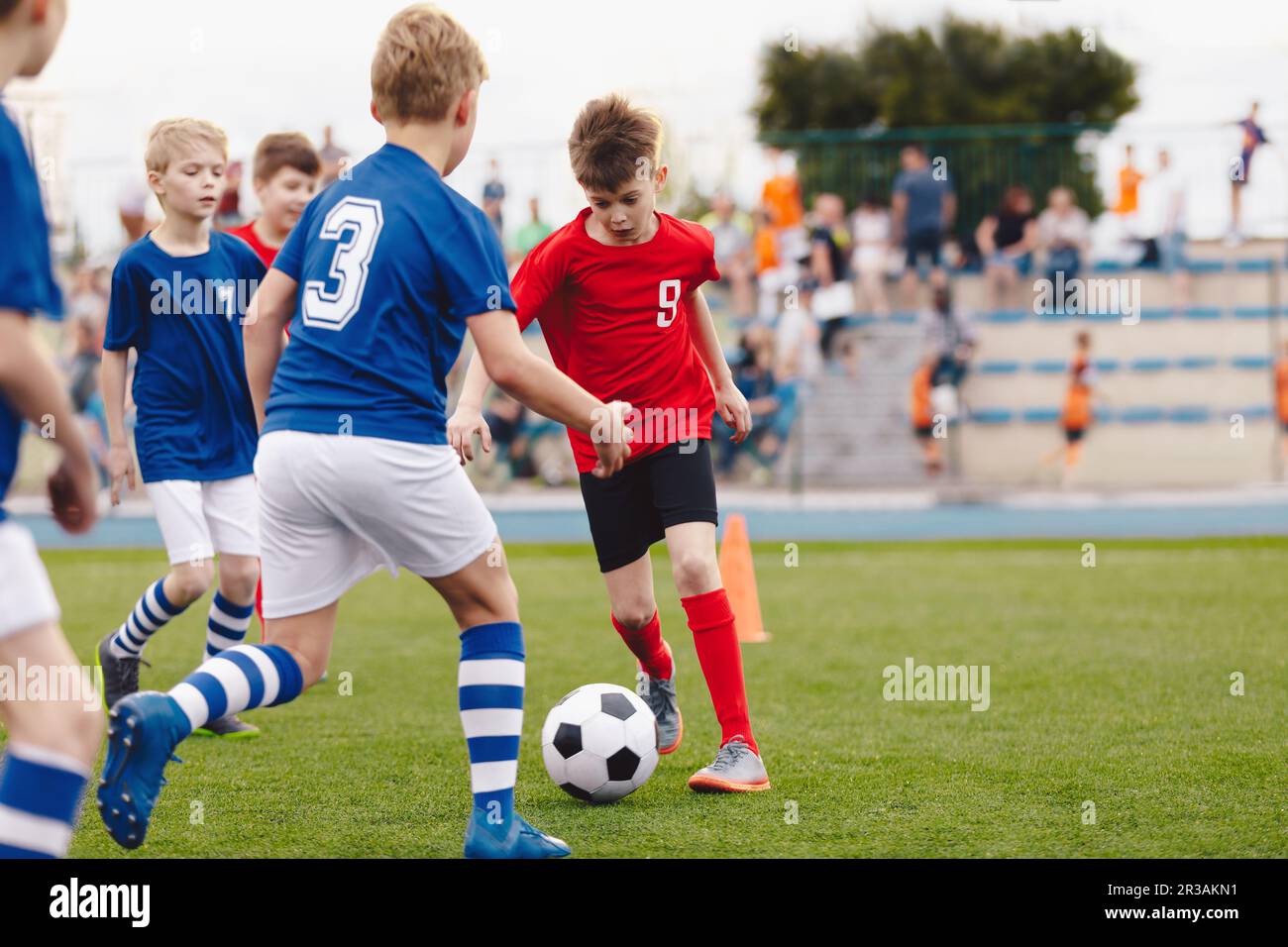 Kids Kicking Football Ball. Youth Players Kicking Soccer Match on Grass ...