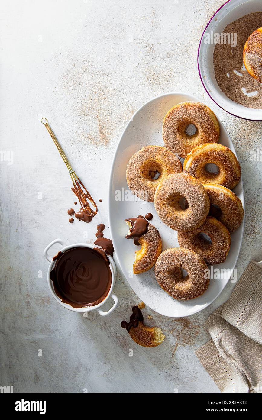 Baked donuts coated with cinnamon sugar and served with dipping ...