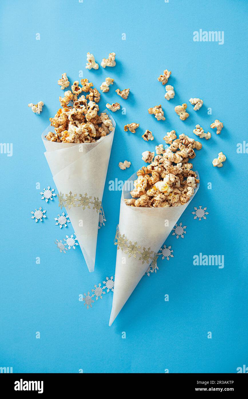 Christmas popcorn with maple syrup, cinnamon and orange zest in a paper ...
