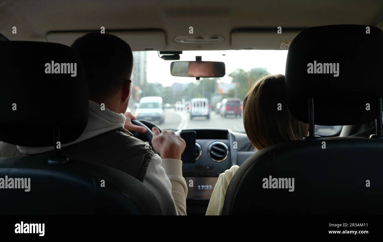 Adult man driving car and dancing with little teen daughter moving ...
