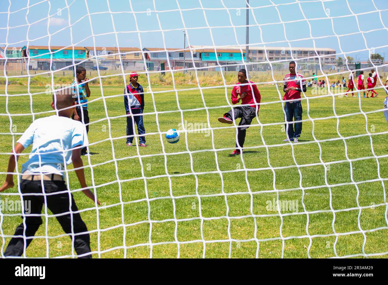 Diverse children playing soccer football at school Stock Photo - Alamy