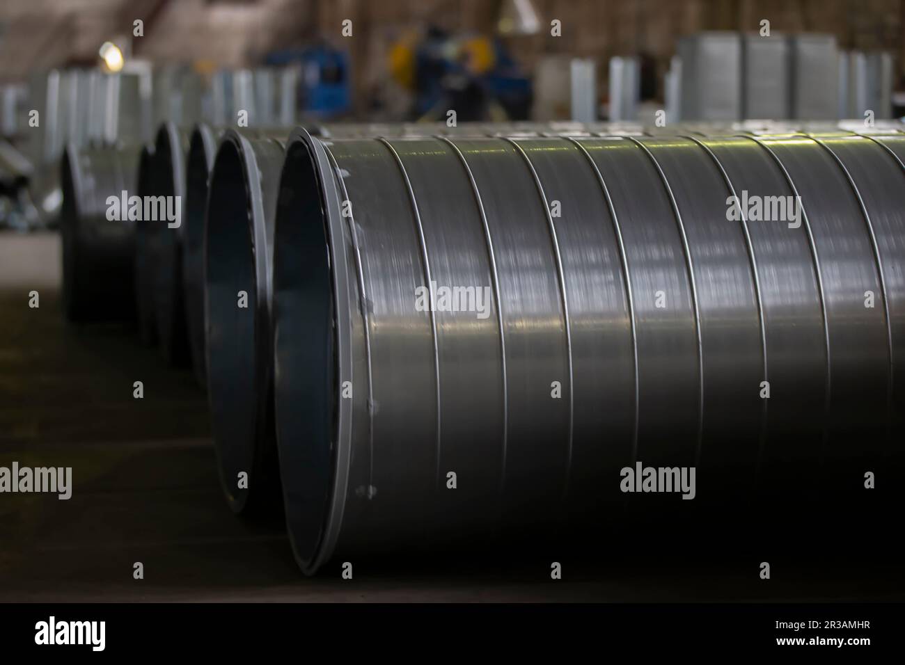 Metal stainless ventilation pipes at a metallurgical plant. Rolled ...