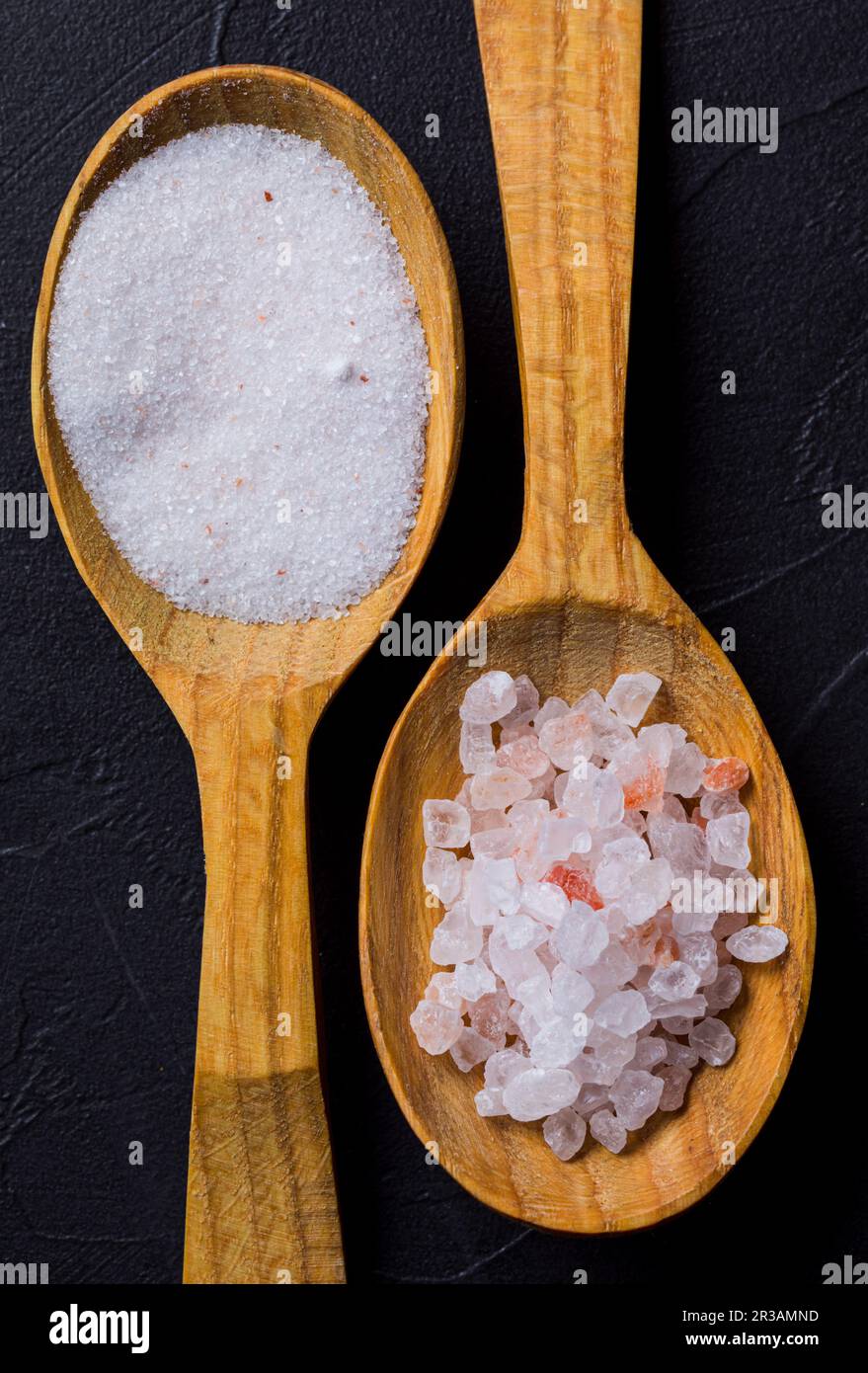Different types of salt in two wooden spoons Stock Photo - Alamy