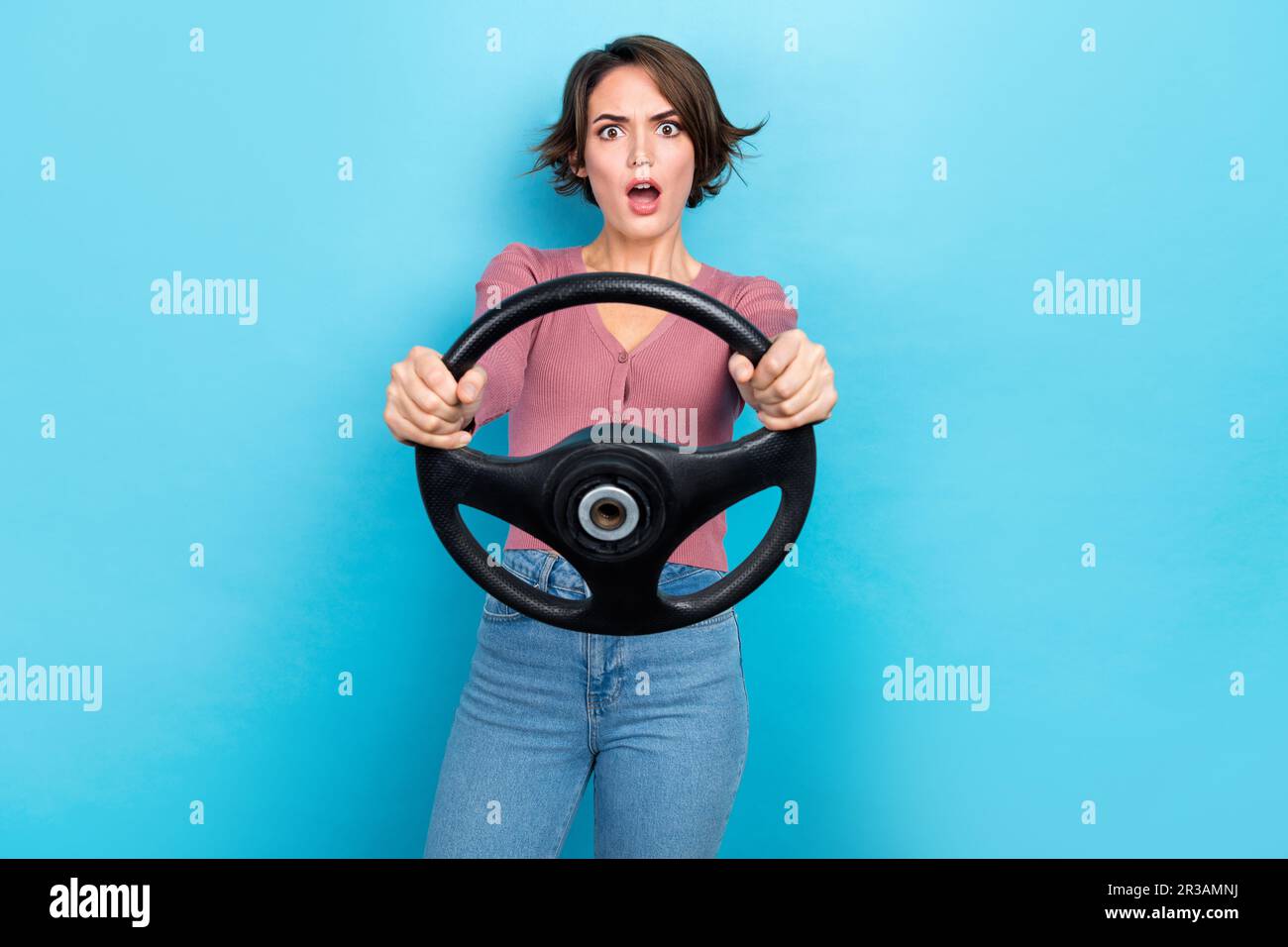Photo of young confused driver automobile girl hold steering wheel open ...