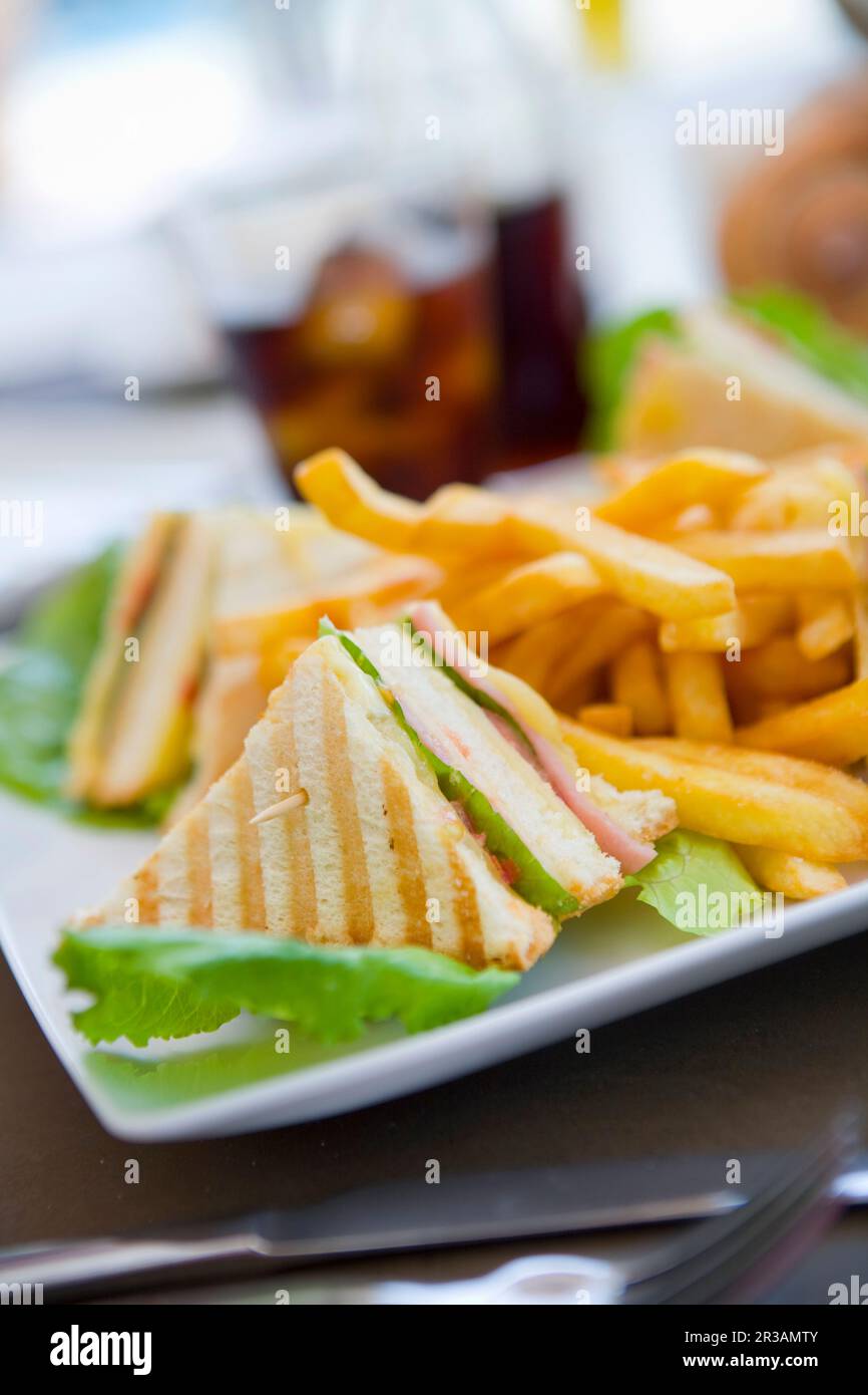 Club sandwich with French fries Stock Photo - Alamy
