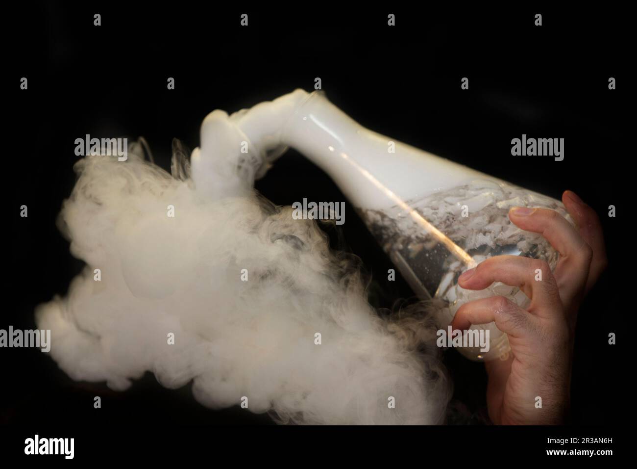 Glass flask with puffs of smoke as a result of liquid nitrogen reaction ...