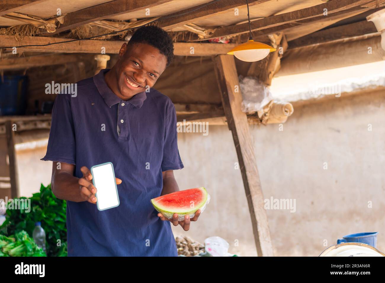 African trader carrying watermelon in a local african market and ...
