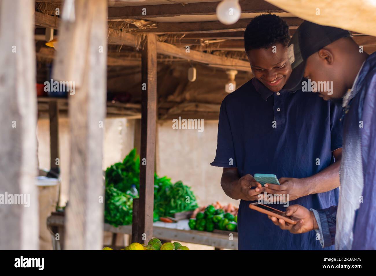African market man and customer performing transaction for payment in a ...