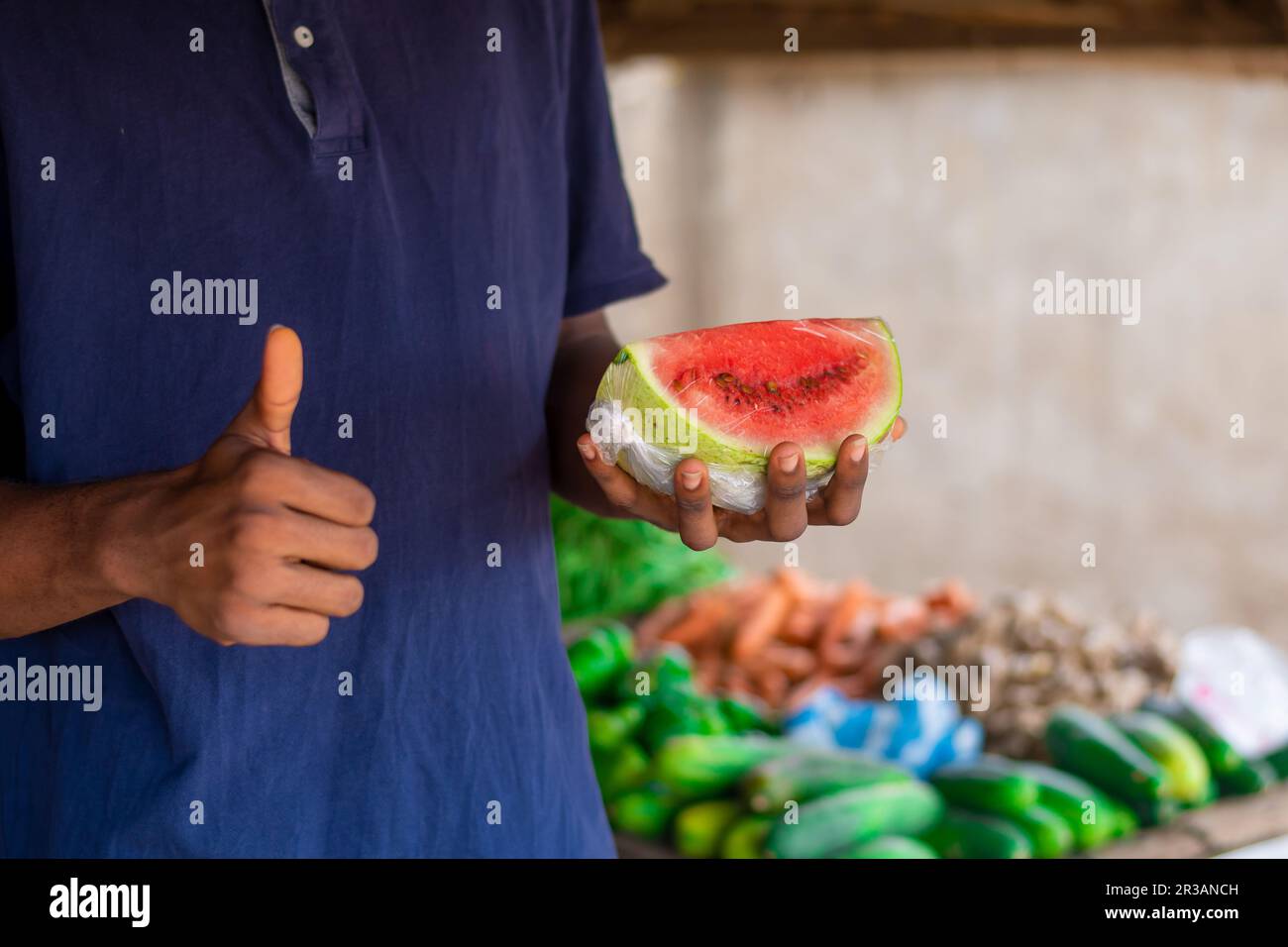 copy space image of a young african male trader holding watermelon and ...